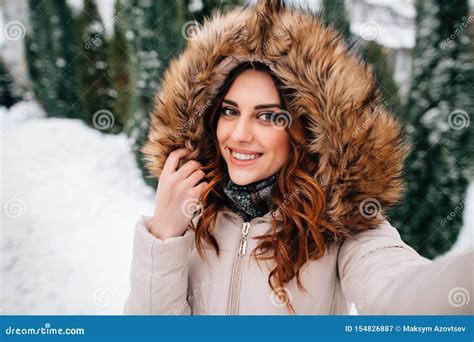 Beautiful Girl In Fur Hood Takes Selfie In Snowy Winter Day Stock Image Image Of Beauty
