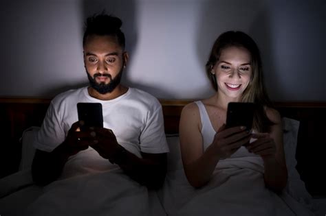 Free Photo Man And Woman Checking Their Phone Before Sleeping