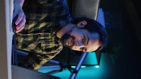 Freelancer In Neon Lit Home Office Sitting At Desk And Typing On Laptop Stock Footage Video Of