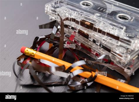 Audio Cassette And Pencil On A Black Table Old Magnetic Data Carrier