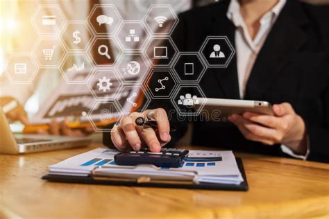 Businessmen Or Financial Data Analysts Working With Tablets And Laptop Computers And Data Graphs