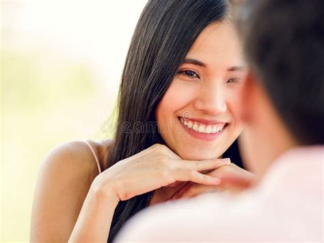 A Young And Cute Beautiful Asian Woman And Her Boyfriend Talking With