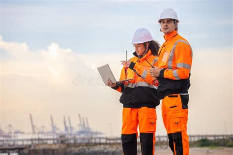 Dock Worker Working At Harbor Site Industrial Engineers Collaborating At Port Terminal With