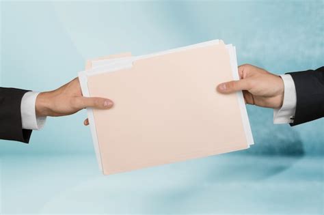 Premium Photo Businessman And Woman Handing Paper File Folder