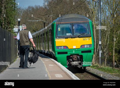 Class 321 Passenger Train In London Midland Livery Arriving At A Small