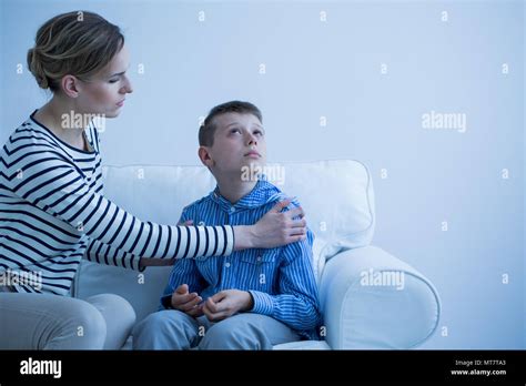 Mother And Her Autistic Son Sitting On The Sofa Stock Photo Alamy