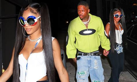 Saweetie Almost Spills Out Of Her Bustier As She Holds Hands With Beau YG While Heading To Hot