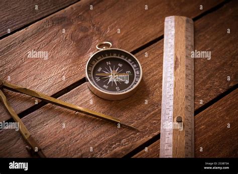 Vintage Ruler Drawing And Navigational Compass On A Rustic Wooden