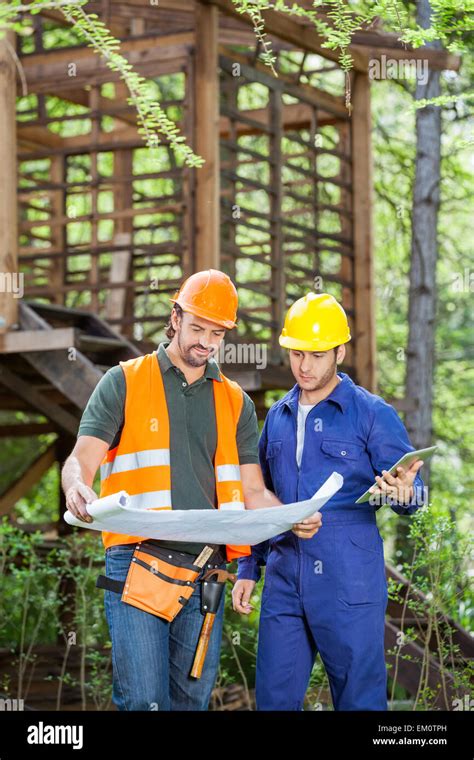 Engineers Analyzing Blueprint At Construction Site Stock Photo Alamy