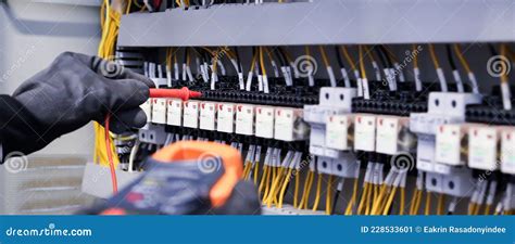 Engineer Using Measuring Equipment Checking Electric Current Voltage At Circuit Stock Image