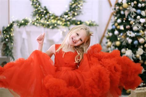 Joyful Girl In Red Dress Celebrating Christmas With Enthusiasm A Young