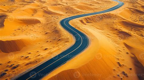 Winding Road Through Expansive Desert Sand Dunes At Dawn With Golden
