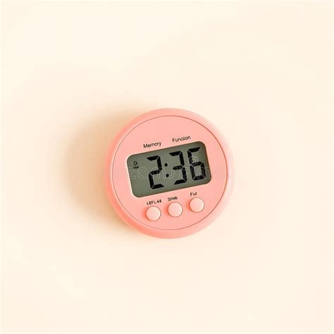 A Compact Pastel Coral Digital Thermometer With A Memory Function On A Light Beige Background