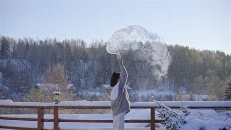 A Girl Makes A Icy Firework From Boiling Water In Winter Slow Motion