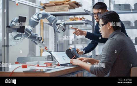 Black Male Engineer Shares His Ideas With Asian Developer While