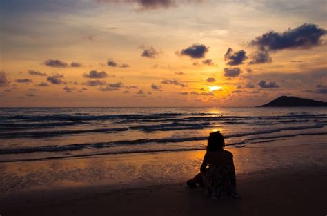 Girl Sitting On Beach Sunset