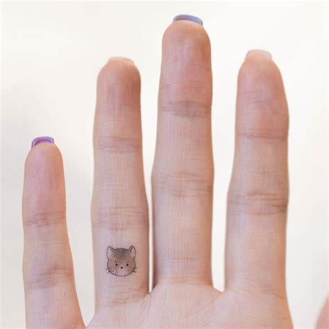 Micro Cat Portrait Tattoo Located On The Finger