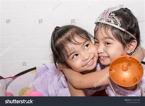 Female Asian Identical Twins Sitting On Stock Photo Shutterstock