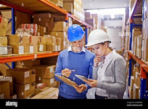 Order Status On Its Way A Man And Woman Inspecting Inventory In A