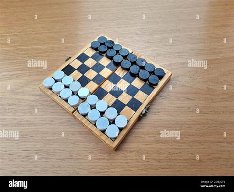 Checkerboard With Checkers Business Strategy Planning Plastic Checkerboard On Brown Wooden