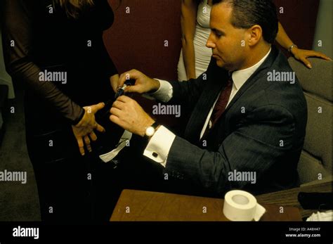 Private Detective Fitting A Concealed Tape Recorder To A Woman Who Is Used To Test Mens Fidelity