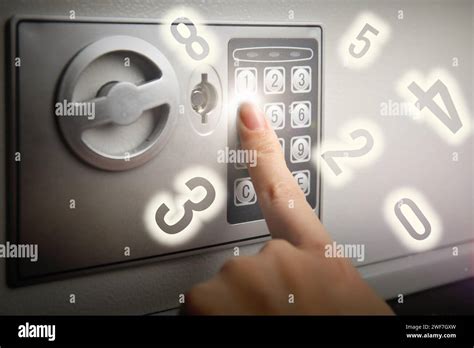 Woman Pressing Buttons On Keypad To Lock Steel Safe Closeup Numbers Symbolizing Code