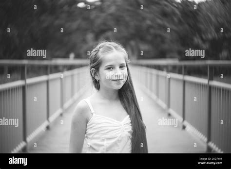 Portrait Of A Beautiful Girl With Long Hair Standing On A Bridge Black