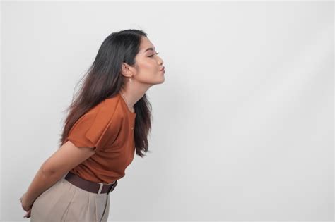 Premium Photo Cute Asian Woman In Brown Shirt Sending Blowing Kiss