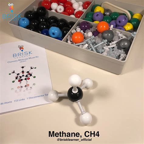 An Assortment Of Colorful Beads In A Container Next To A Notepad With