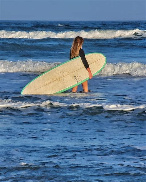 Premium Photo Girl Surfing In Sea
