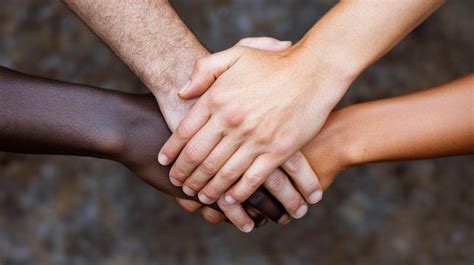 Hands Holding Together Symbolizing Unity Closeup Of Hands Interlocking And Holding Together