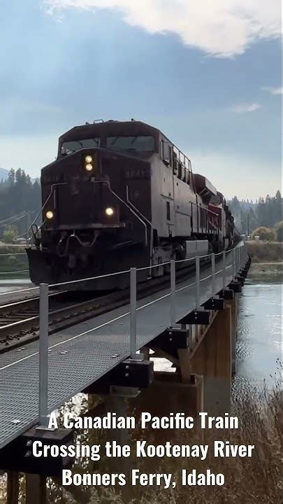 A Canadian Pacific Railway Train Crossing The Kootenay River In Bonners