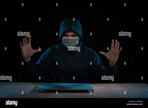 Asian Hacker Hacking Computer Network With Laptop In Dark Cyber Security Concept Stock Photo