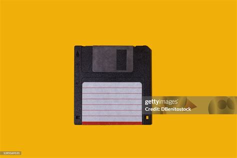 Black Retro 35 Floppy Diskette With White And Red Label On Yellow Background Concept Of