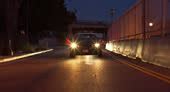 Cop Car Driving Under Bridge Onto Dtla Street At Night 4k Stock Video