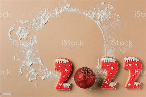 숫자 2022의 모양에 진저 브레드의 평평한 평지와 흩어진 밀가루와 베이지 색 배경에 빨간 공 엽서 템플릿 광고 공간을 복사합니다 0명에 대한 스톡 사진 및 기타 이미지