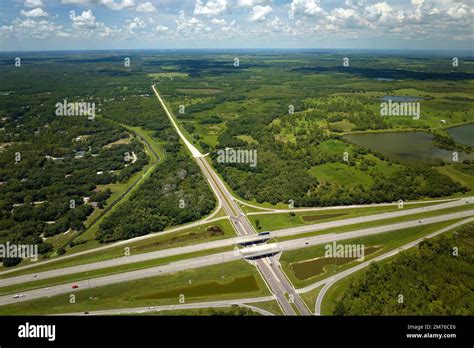 Aerial View Of Freeway Overpass Junction With Fast Moving Traffic Cars And Trucks Interstate