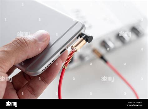AUX Cable Connected Between Smartphone And Mini Amplifier Cable For Stereo Input And Output
