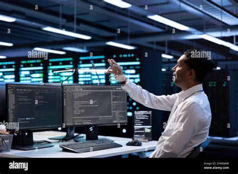 Software Developer Looking At Holograms In Data Center Monitoring