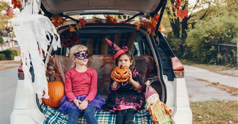 트릭 또는 트렁크 어린이 형제 자매는 차 트렁크에서 할로윈을 축하합니다 10 월 휴일 야외를 준비하는 친구 어린이 소녀