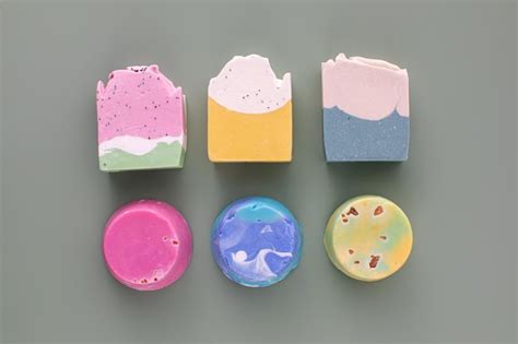 Pieces Of Different Shapes And Colors Of Handmade Soap On A Green Background Natural Cosmetics