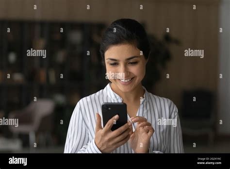 Happy Young Indian Woman Smartphone User Chatting At Social Network