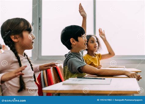 Student In Classroom Peering Into Microscope Royalty Free Stock Image