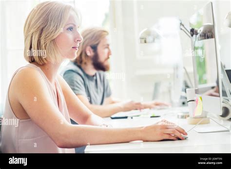 Male And Female Designers Using Desktop Computers In Creative Studio Stock Photo Alamy