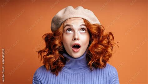 Surprised Redhead Woman With Beret On Isolated Background Looking At Camera Mouth Open