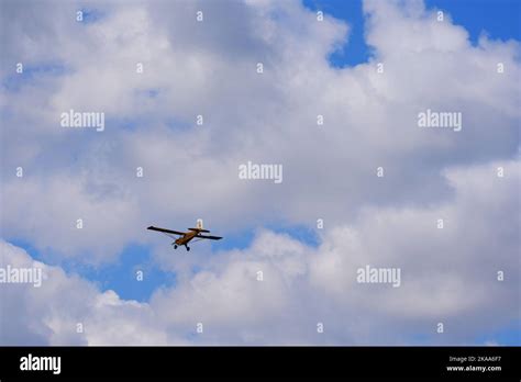 Small Single Engine Propeller Plane Flying Within Clouds In A Sunny Day