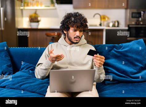 Thoughtful Bearded Man Looking At Laptop Display Dont Understand
