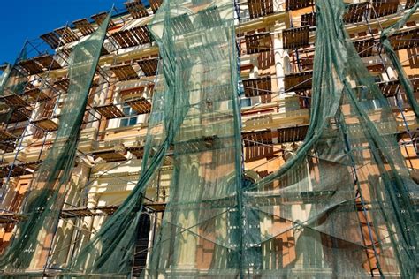 Premium Photo Building Structure With Netting Shade And Scaffolding Covered