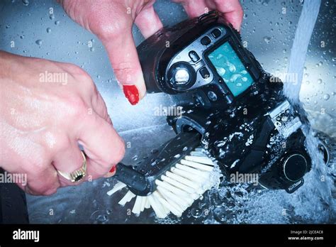 Female Hands Washing Dslr Camera As Dirty Dishes Running Water In The Sink Crazy Photographer