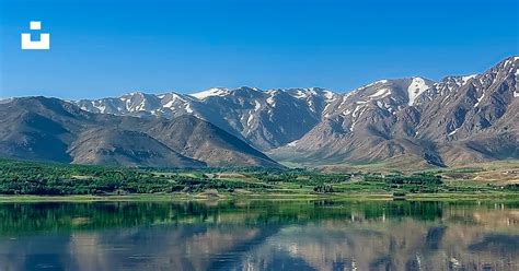 호수의 잔잔한 물에 산맥이 반사됩니다 사진 Unsplash의 무료 풍경화 이미지